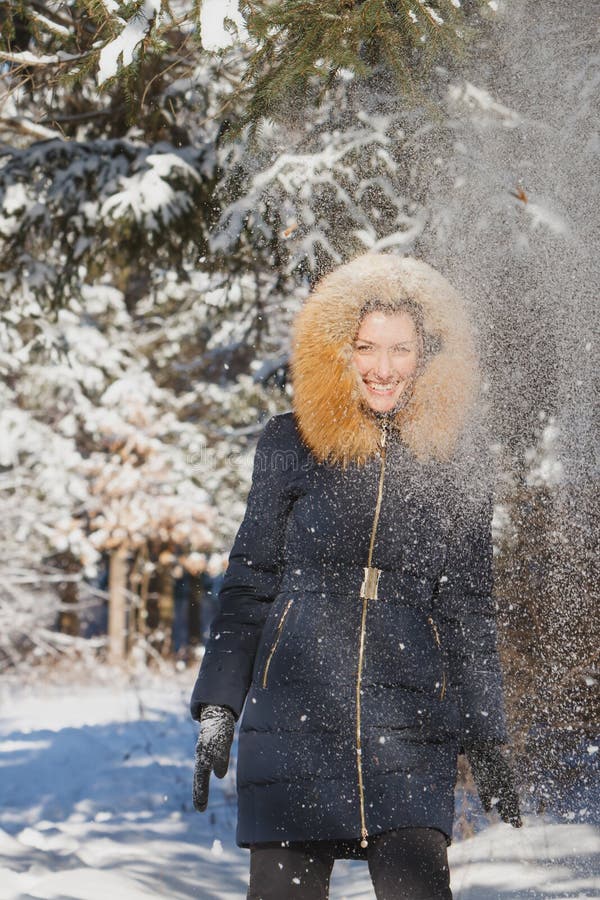 Happy Young Woman Standing Under Falling Snow Stock Photo - Image of ...