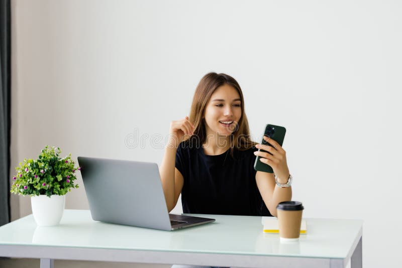 Happy Young Woman Working Using Multiple Devices on a Desk at Home ...
