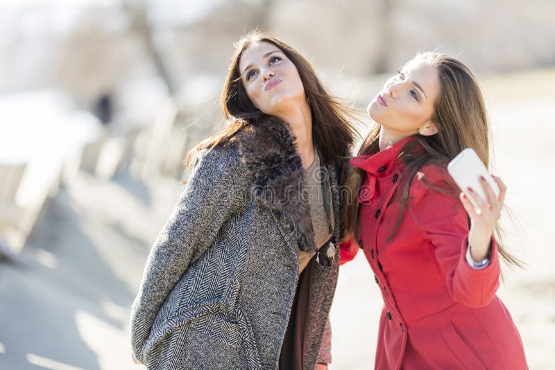 Happy Young Women Taking Photo with Mobile Phone Stock Photo - Image of ...