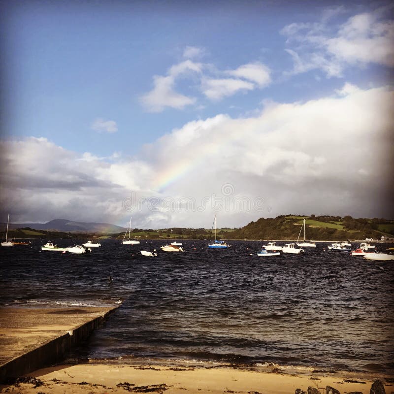 Harbour scene with rainbow stock image. Image of harbour - 142041701