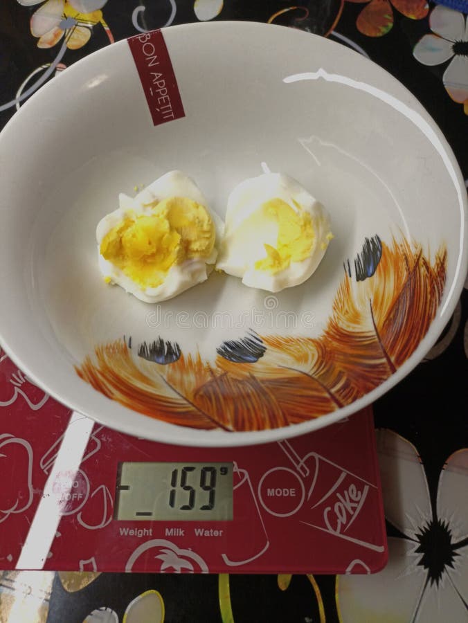 A Hard-boiled Egg, Broken in Half on a Kitchen Scale. Stock Image ...