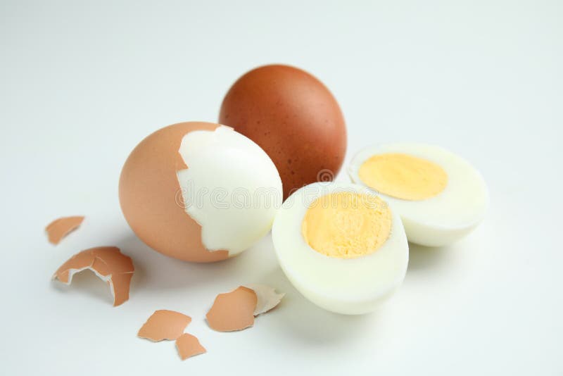 Hard Boiled Eggs and Pieces of Shell on White Background Stock Photo ...