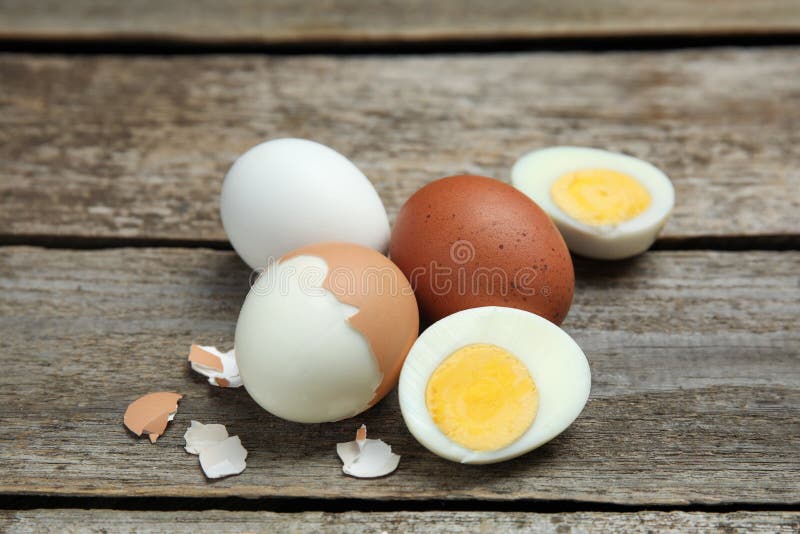 Hard Boiled Eggs and Pieces of Shell on Wooden Table Stock Image ...