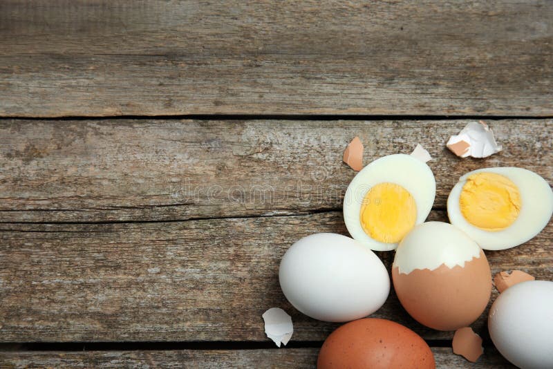 Hard Boiled Eggs And Pieces Of Shell On Wooden Table Flat Lay Space For Text Stock Image