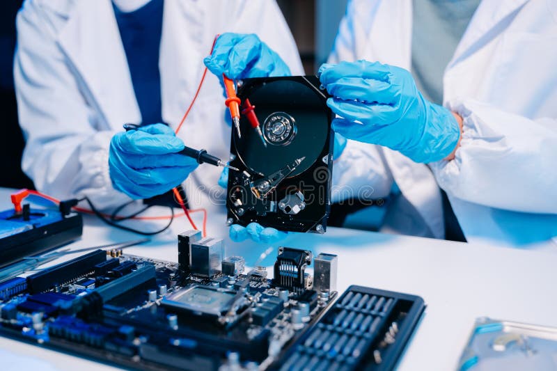 Hard Disk Drive on the Technician S Desk and a Computer Motherboard As ...