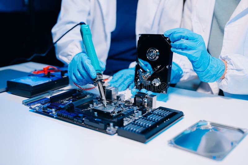 Hard Disk Drive on the Technician S Desk and a Computer Motherboard As ...