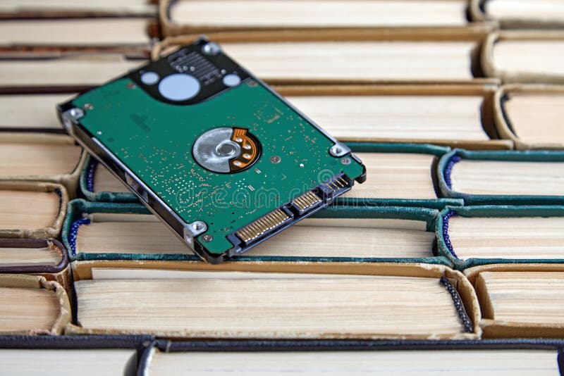 Hard Drive on a Stack of Old Shabby Paper Books. Comparison of Storage ...