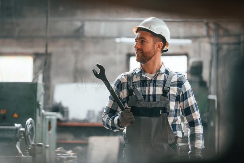 In Hard Hat. Factory Male Worker in Uniform is Indoors Stock Image ...