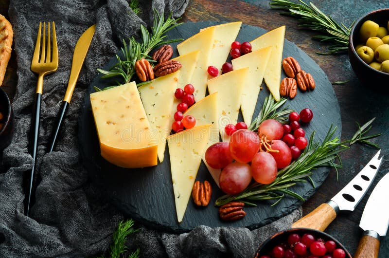 Hard Nut Cheese with Nuts on a Plate with Snacks. Free Copy Space Stock ...