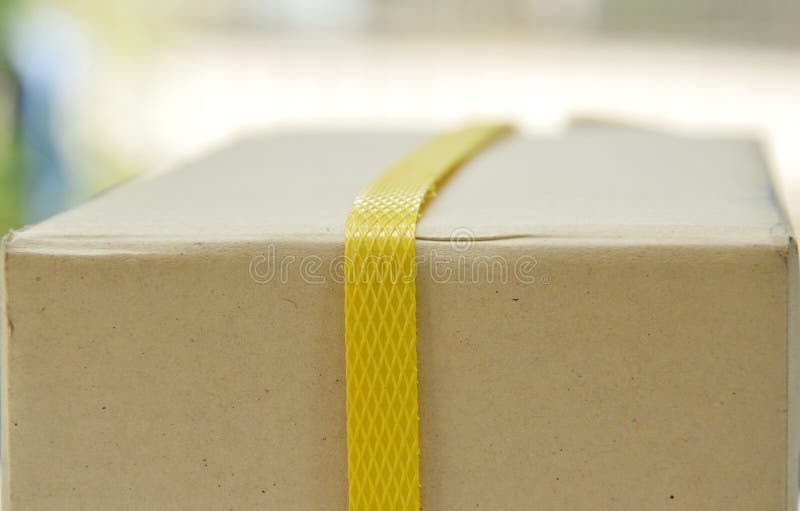 Hard Paper Parcel Wrapped by Yellow Plastic Band Stock Image - Image of ...