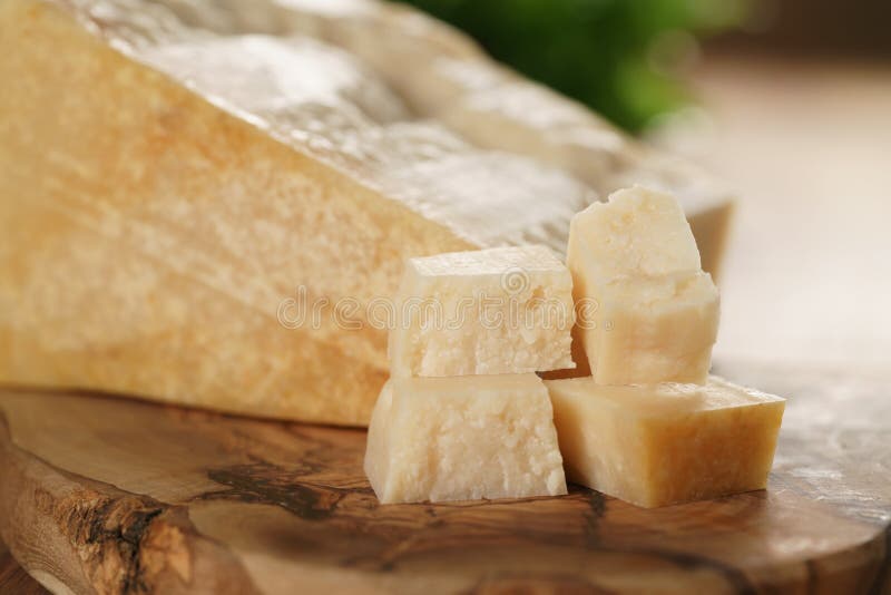 Hard Parmesan Cheese Cubes on Olive Cutting Board Stock Image - Image ...