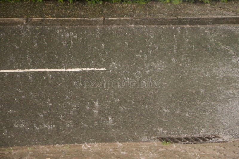 Hard Rain Falls in Puddles on the Street Stock Photo - Image of ...
