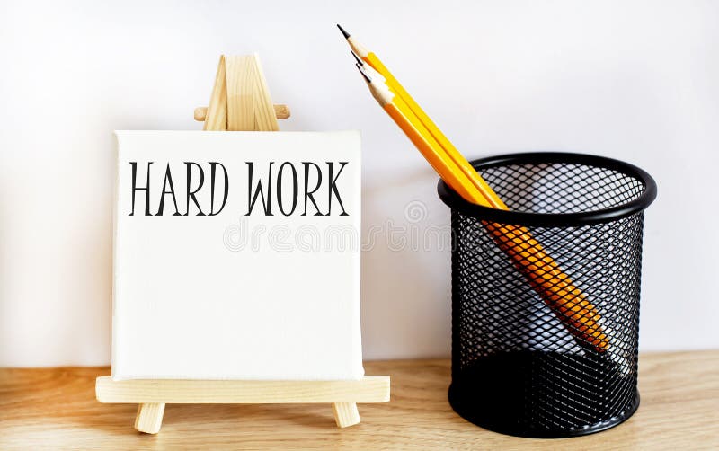HARD WORK Concept Written on a Small Blackboard on the Easel Stock ...