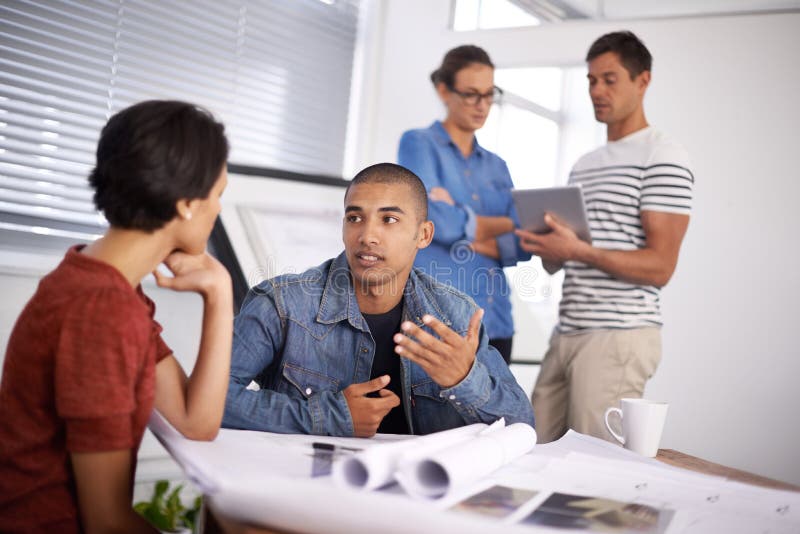 Hard at Work Creating the Perfect Design. a Group of Young Designers ...