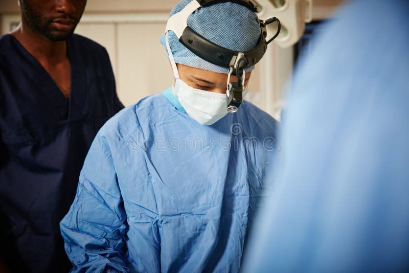 Hard at Work in the ER. a Team of Surgeons Performing a Surgery in an ...