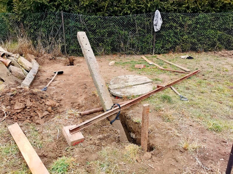 Hard Work in the Garden, Pulling a Concrete Column Out of the Ground ...