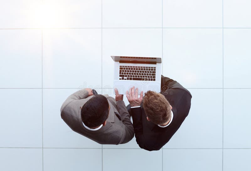 Two Successful Smiling Businessmen are Working on a Laptop. View from ...