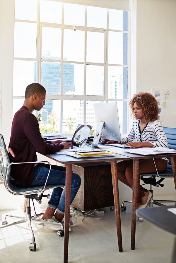Hard Work always Pays Off. Colleagues Working on Their Computers at a ...