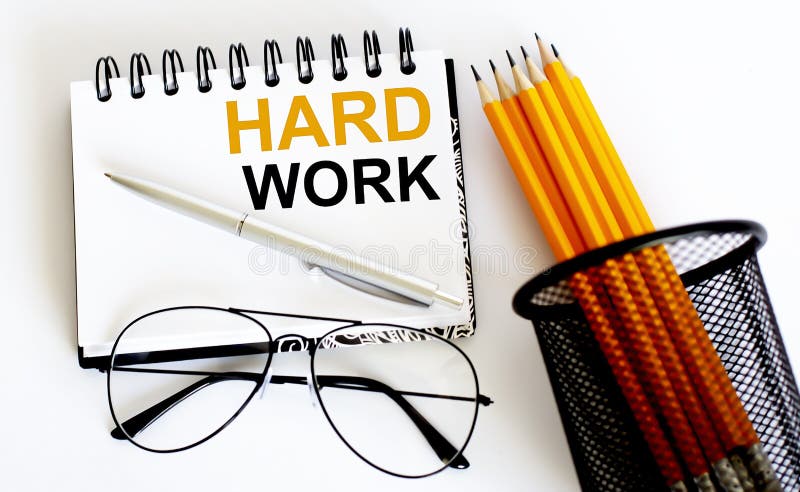 HARD WORK AHEAD Text on a Blue Pieces of Paper on Yellow Background ...