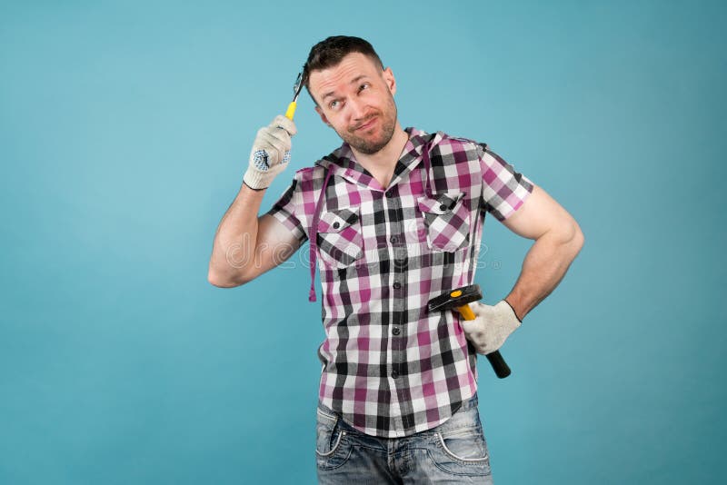 The Hard Worker is Puzzled by Something and Scratches His Head Stock ...