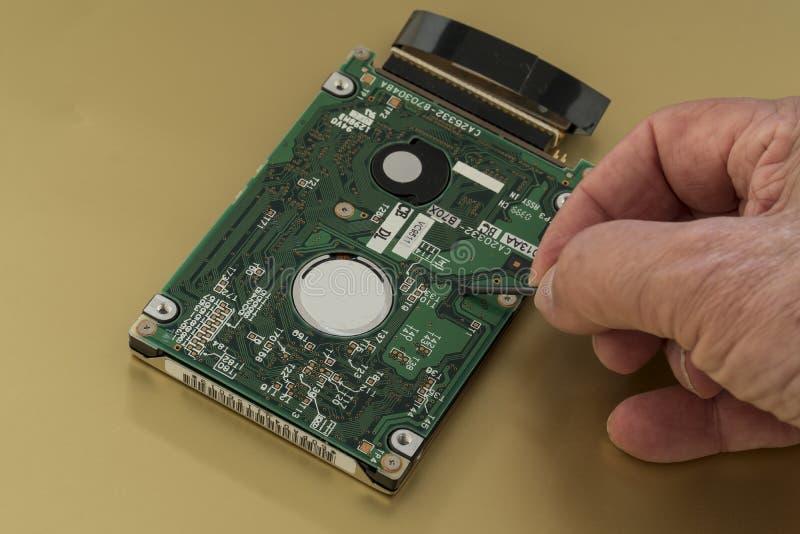 Harddrive from a Laptop Computer is Being Inspected by a Technician ...