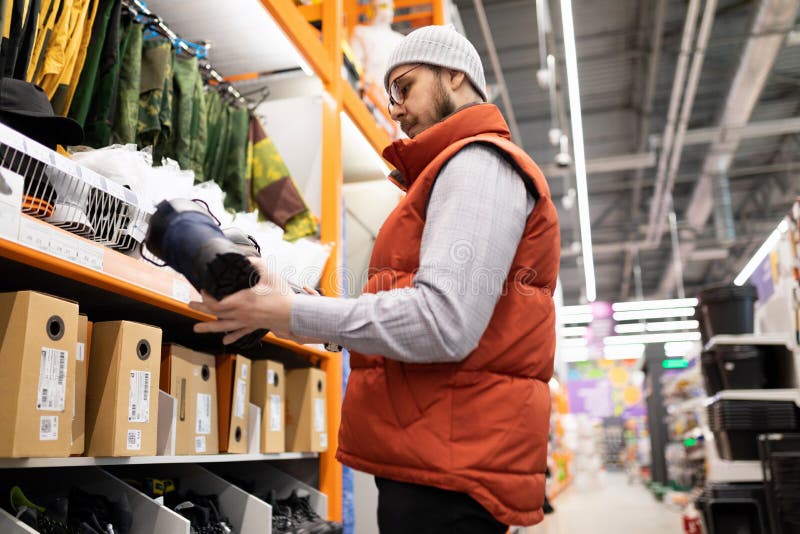 Hardware Store Customer Chooses Shoes To Work on a Construction Site ...