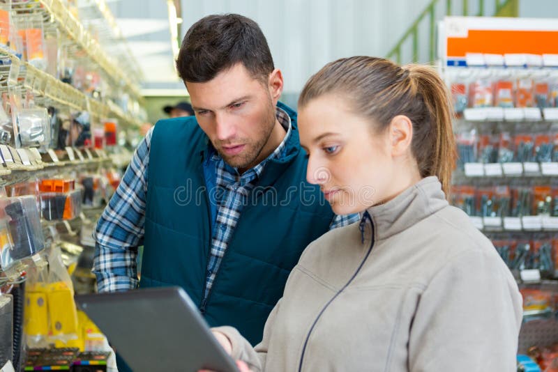 Hardware Workers Looking at Tablet Stock Image - Image of student ...