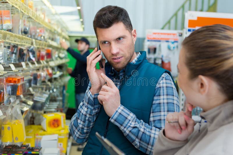Hardwarer Store Worker with Craftsman Buyer on Phone Stock Image ...