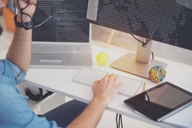 Hardworking Man Using Laptop and Computer in an Office Stock Photo ...