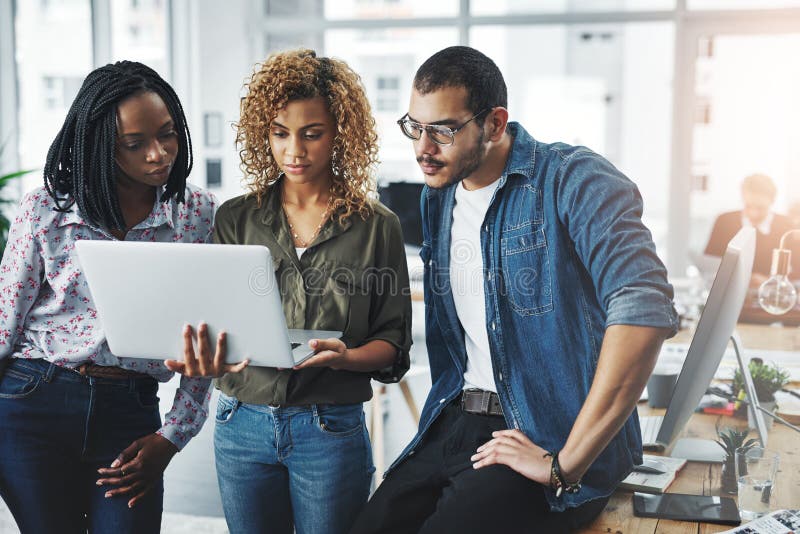 Hardworking Teams are Winning Teams. a Group of Colleagues Using a ...