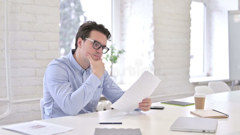 Hardworking Working Young Man Thinking and Writing on Paper Stock ...