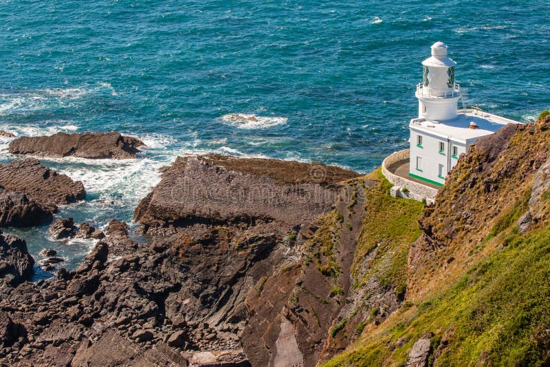 Hartland Point Lighthouse Surrounded by the Sea and Rocks Under a ...