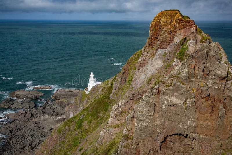 Hartland Point Lighthouse Surrounded by the Sea and Rocks Under a ...