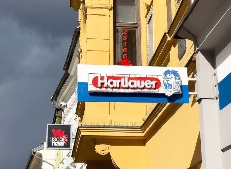 Hartlauer Sign on Yellow Building Facade in Urban Setting with Dark ...