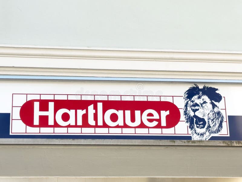 Hartlauer Storefront Sign with Lion Graphic on Building Exterior ...