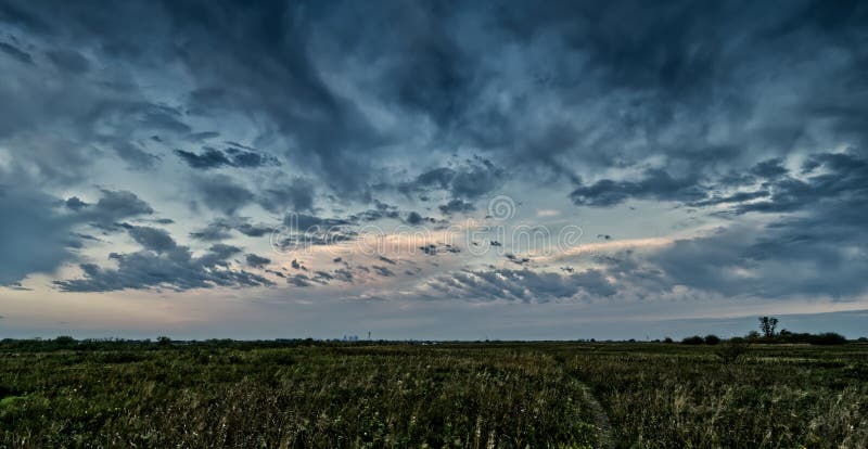 Evening clouds over field stock photo. Image of cloud - 237958330