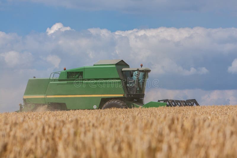 Harvester in corn field editorial photo. Image of reaping - 76700091
