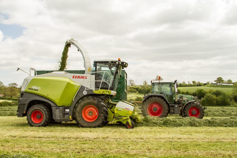 Harvester Cutting Field, Loading Silage into a Tractor Trailer ...