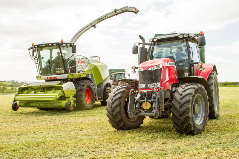 Harvester Cutting Field, Loading Silage into a Tractor Trailer ...
