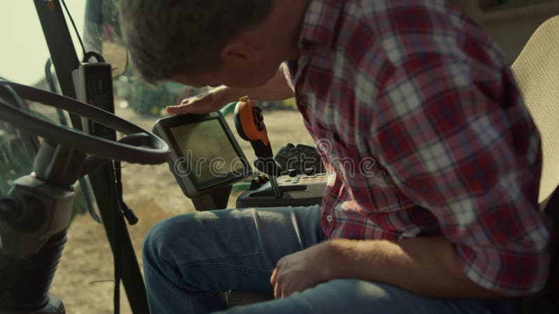 Tractor Driver Checking Harvester Inside Cabin Closeup. Focused Farmer ...