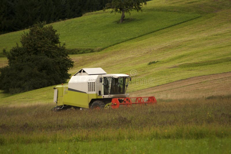 Harvester at work on field stock photo. Image of bale - 48118998