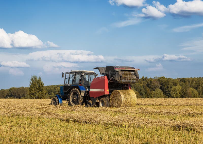 Harvesting hay in a field editorial photo. Image of baler - 76653476
