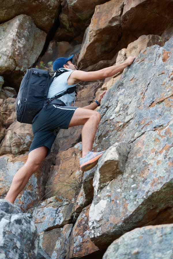He Has a Sure Grip. Young Mountain Climber Scaling a Rock Face. Stock ...