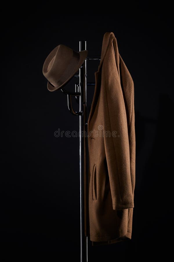 Hat and Classic Jacket Hanging on Coat Rack on Black Stock Photo ...