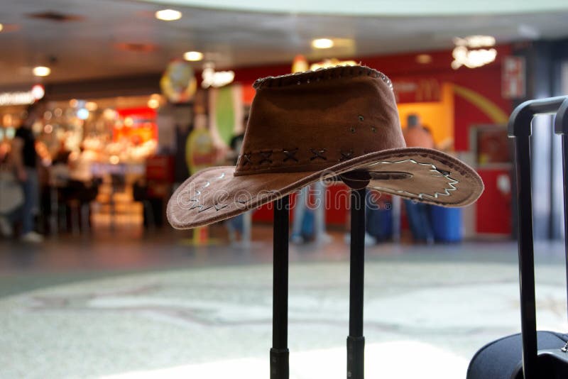 A Hat Resting on a Suitcase Handle Stock Photo - Image of anonymous ...