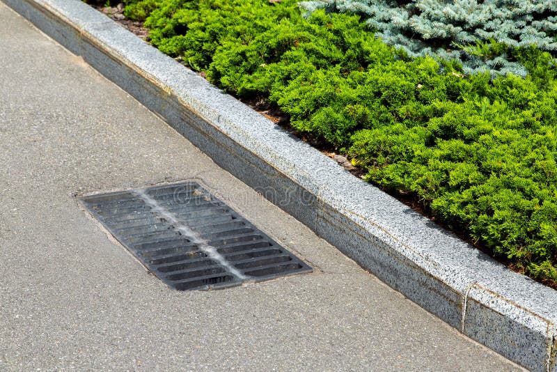 Hatch Storm System with a Grate in the Asphalt Road. Stock Image ...