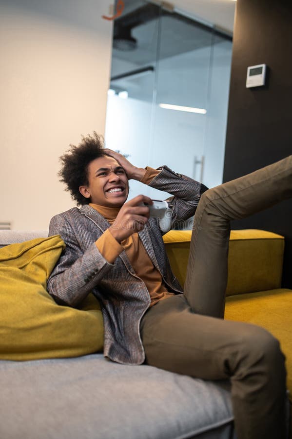 Curly-haired Young Man Looking Excited while Playing Video Games during ...