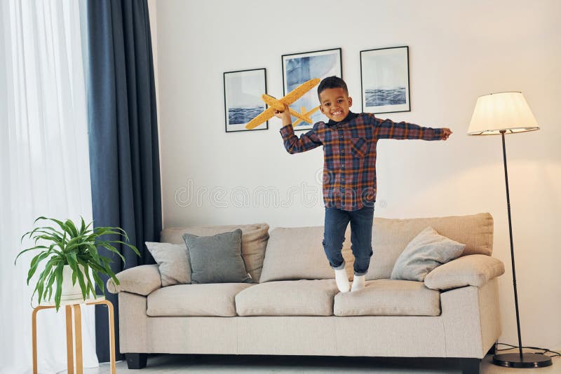 Having Fun. Cheerful Young Boy is at Home Alone Stock Image - Image of ...