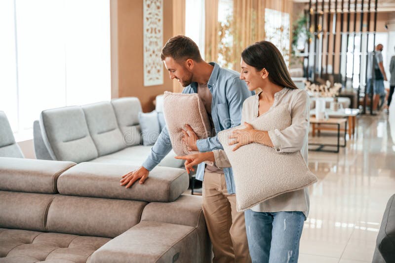 Having Fun by Choosing the Sofa. Couple is in the Store Stock Image ...