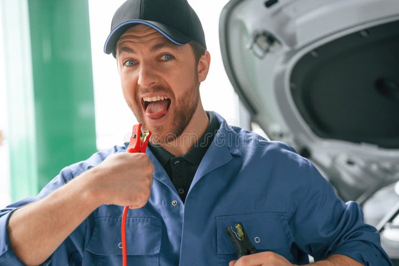 Having Fun with Electrical Terminals, Dangerous. Man in Blue Uniform is ...